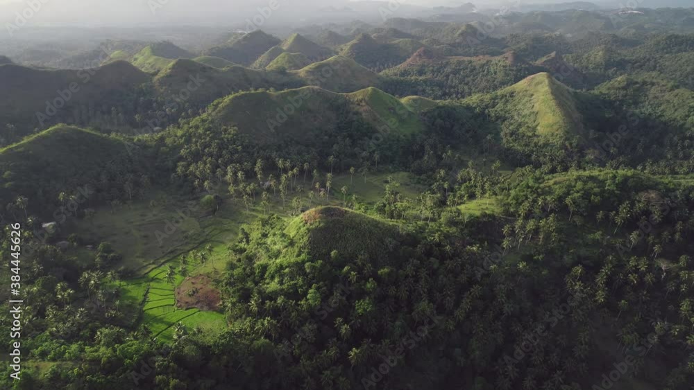 Rural Asia green mountain aerial: fields, valleys with abudant grass ...