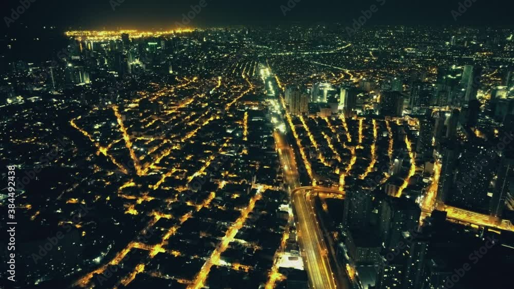 Slow motion illuminated night streets at Manila metropolis aerial view ...