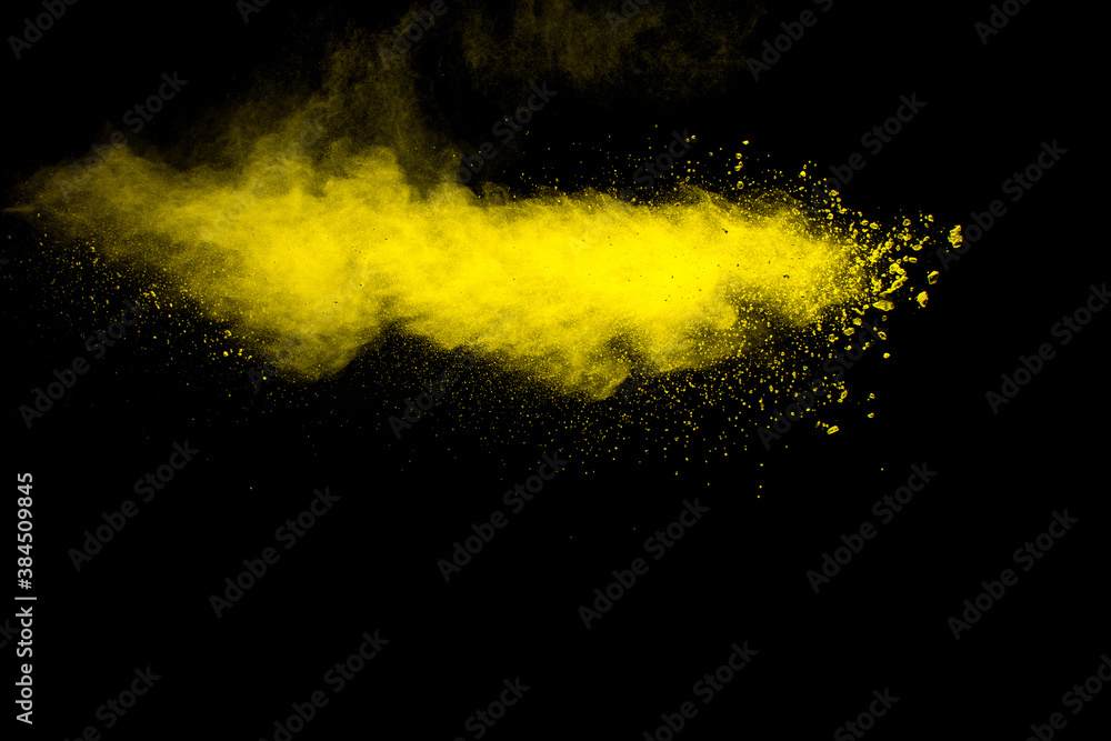 Yellow dust particles explosion on black background.Yellow powder ...