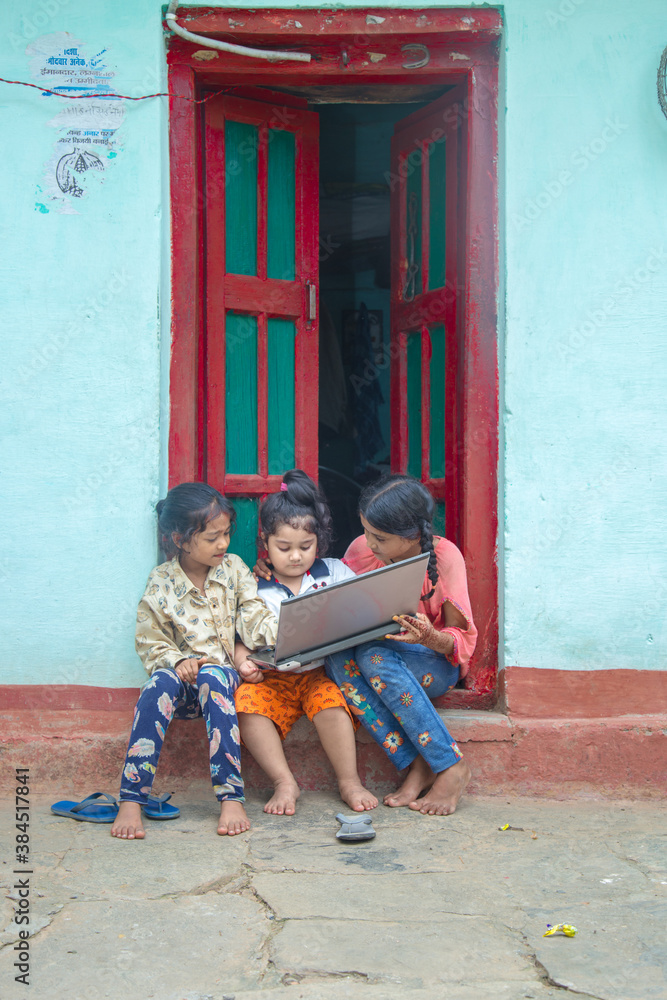 Indian village girls operating laptop computer system seating at home ...