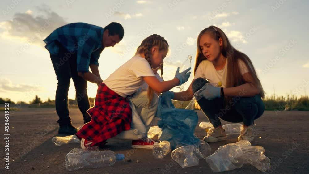 Volunteers father and daughters take away plastic waste. Happy family ...