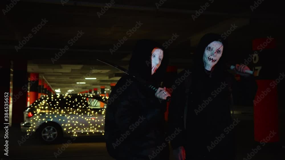 Man in scary white mask mask are holding a baseball bat and katana ...