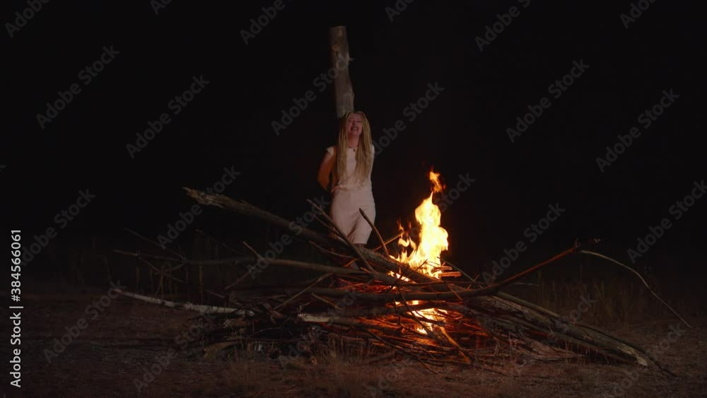 Screaming hopeless beautiful sorceress in white dress tied to wooden ...