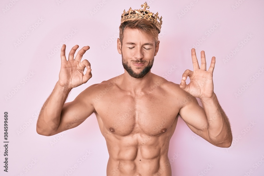 Young caucasian man shirtless wearing king crown relax and smiling with ...