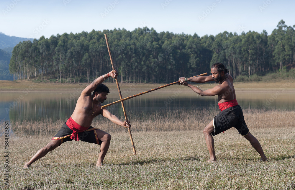 Indian fighters with bamboo sticks performing Kalaripayattu Marital art ...