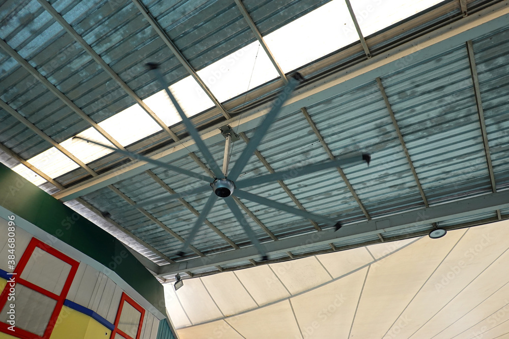 Metal ceiling and large fans for open air shopping mall building. Stock ...