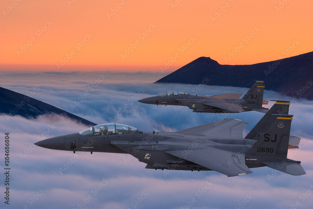 Boeing F-15E Strike Eagle formation flying above the clouds Stock Photo ...