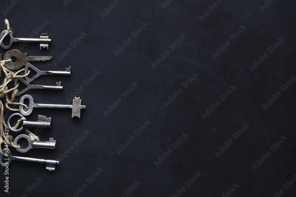 Set of vintage keys for a lock. Retro keys on a dark stone background ...