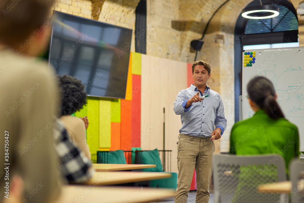 Team Building Training. Confident male business coach or speaker giving ...
