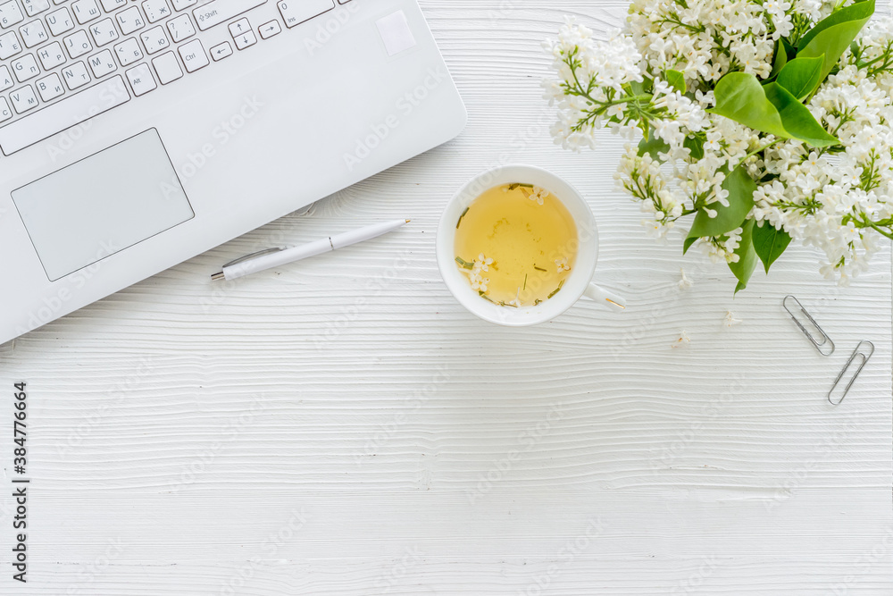Workplace with laptop and flowers bouquet top view Stock Photo | Adobe ...