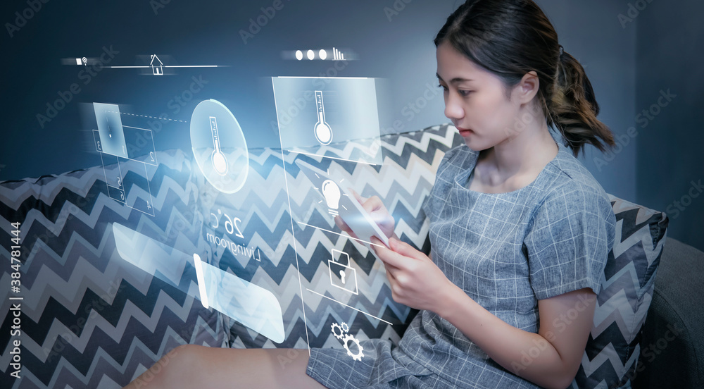 Smart home modern technology Asian girl sitting living room using ...