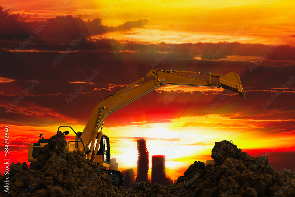 Excavators are digging the soil in the construction site on the sunset ...