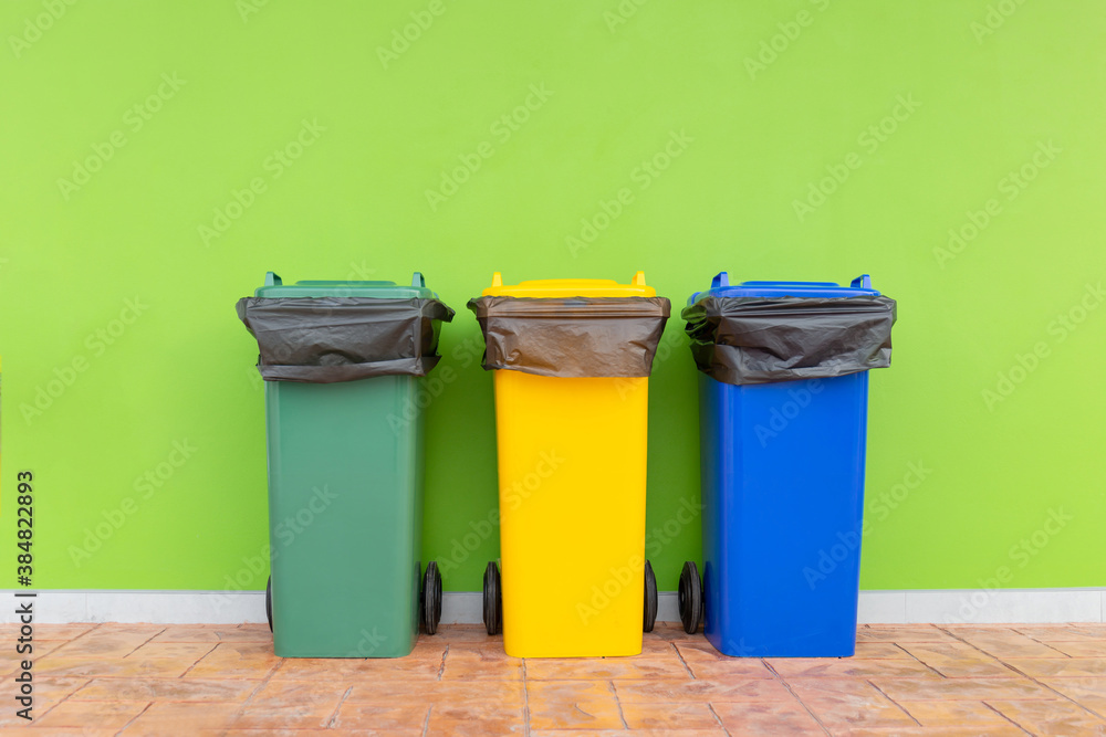 Group of colorful recycle bins green background, Different colored bins ...