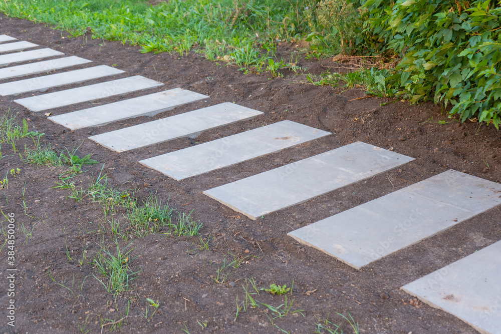 Step path made of concrete slabs in the Park. Step-by-step concrete ...
