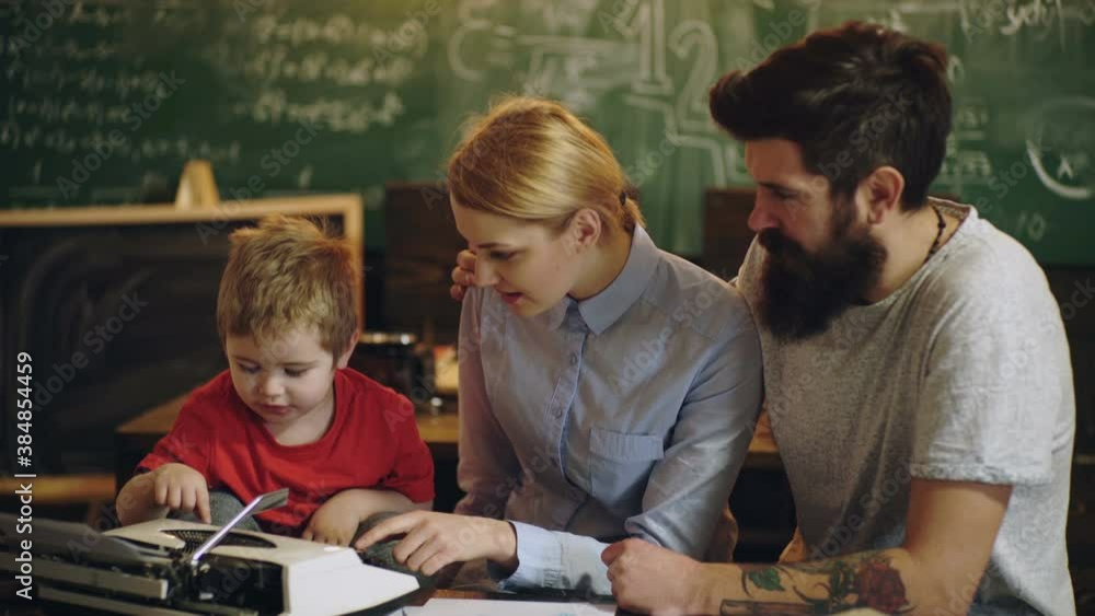 Early childhood education. Teachers day. Family studying. Parents helping child with homework at ...