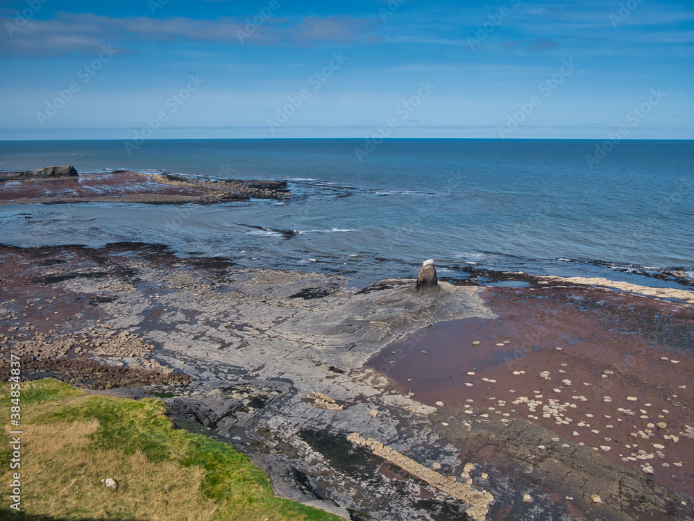 North of Robin Hood's Bay in Yorkshire, UK, low tide reveals the ...