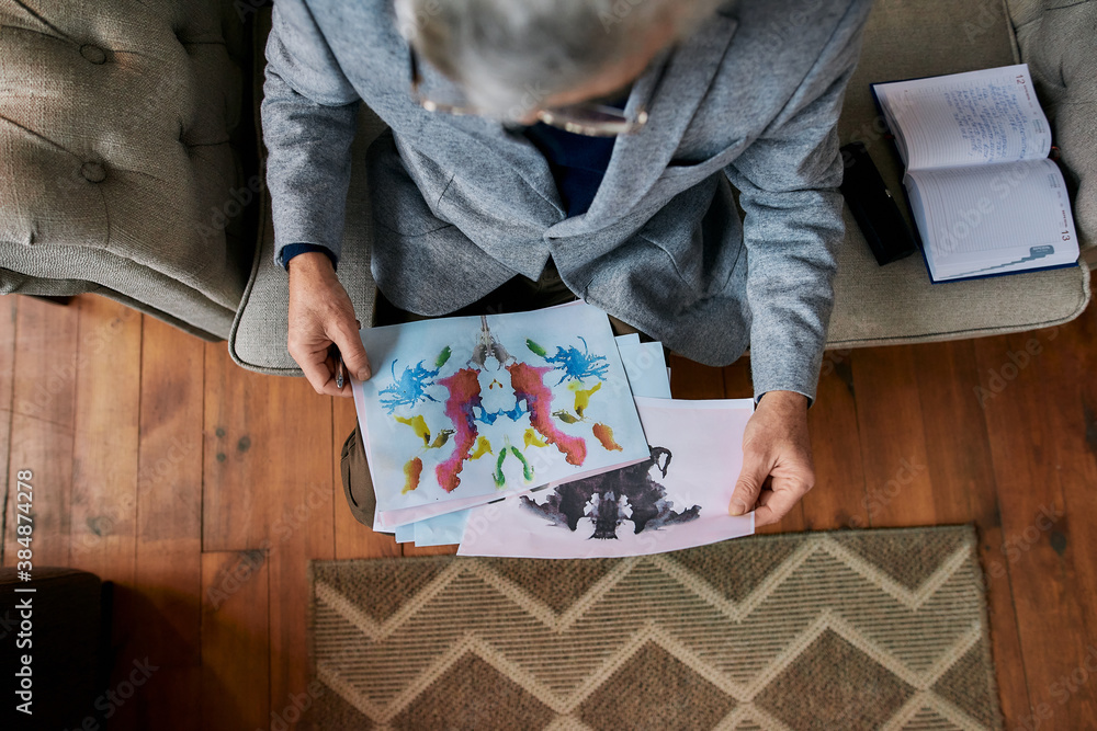 Top view of psychologist choosing picture with ink stain, Rorschach ...