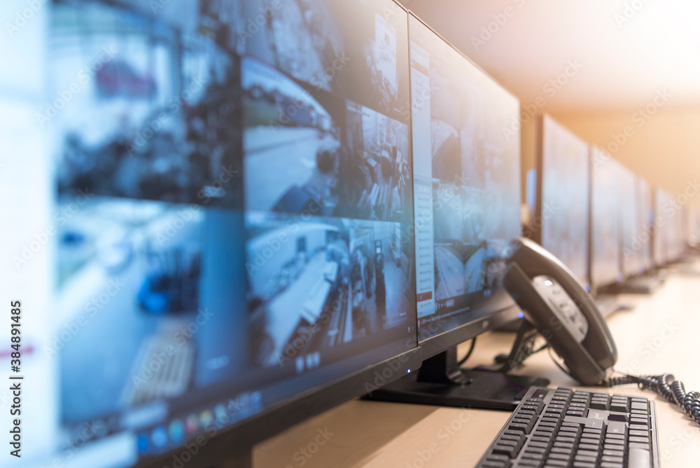 Security guard monitoring modern CCTV cameras in surveillance room ...