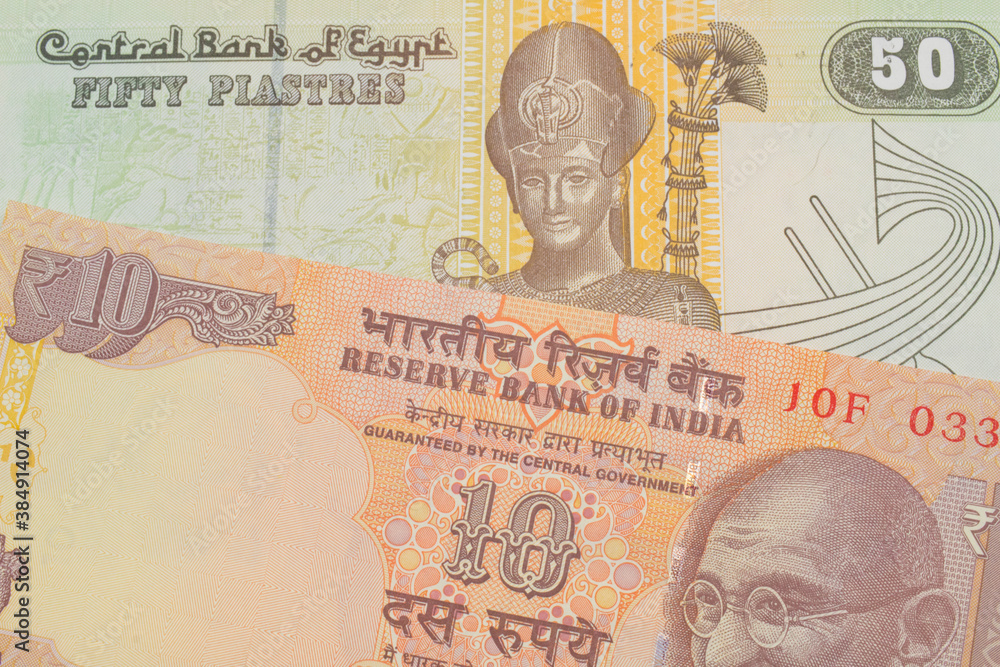 A macro image of a orange ten rupee bill from India paired up with a ...