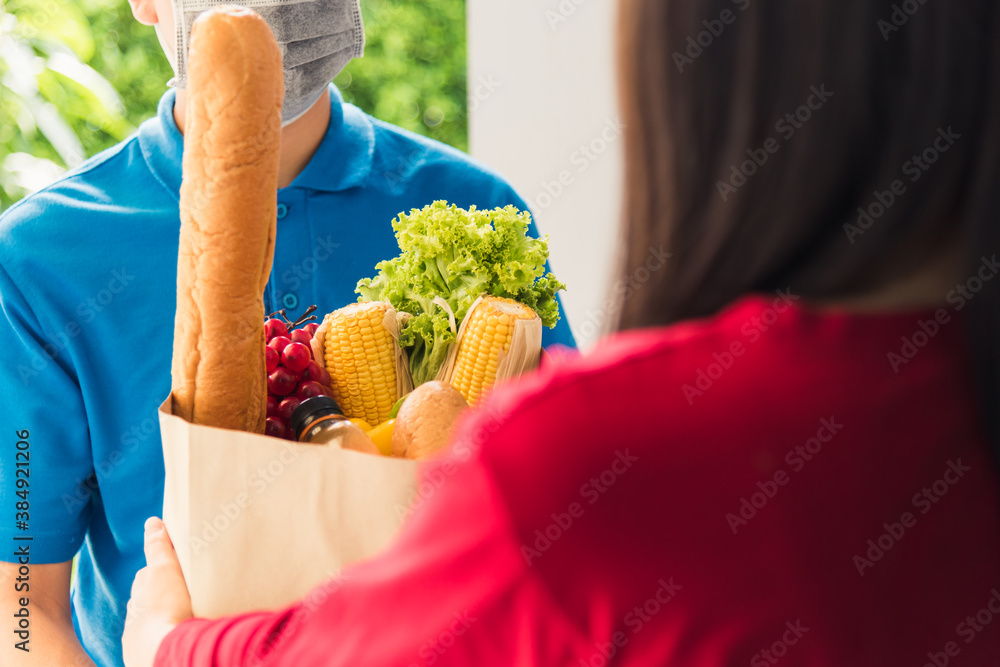 Asian young delivery man in uniform wear protective face mask he making ...