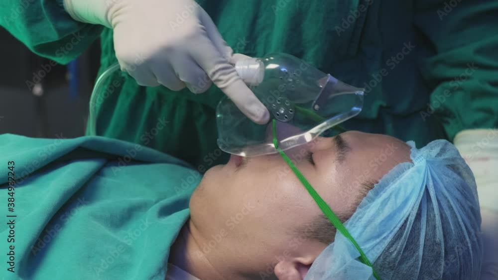 Medical surgery person wears oxygen mask to coma unconscious patient ...