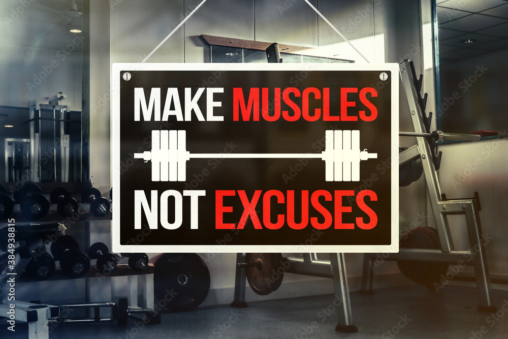 A signage with words - Make Muscles Not Excuses - in front of a gym or ...