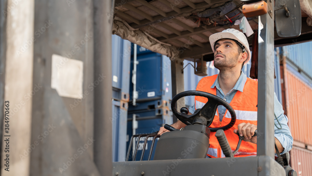 Portrait of Young Caucasian man engineer driving Forklift with white ...