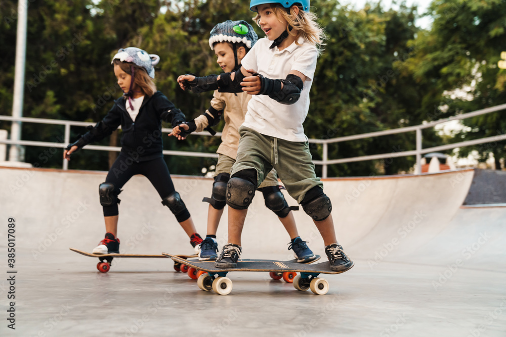 Happy kids on skateboards at the ramp Stock Photo | Adobe Stock