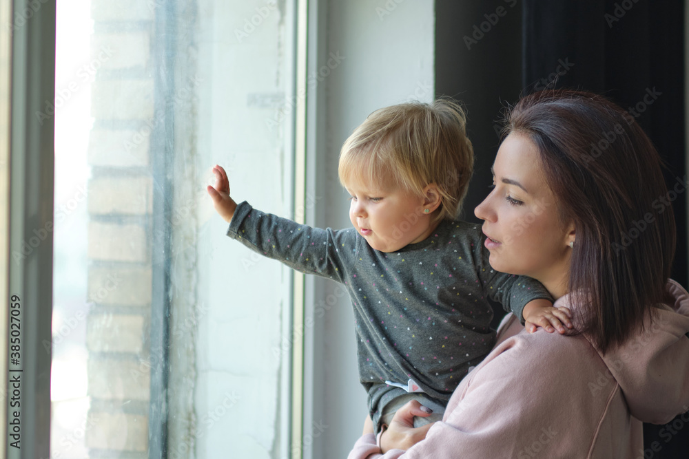 Close up beautiful mom hugging baby in her arm. mother look out the ...