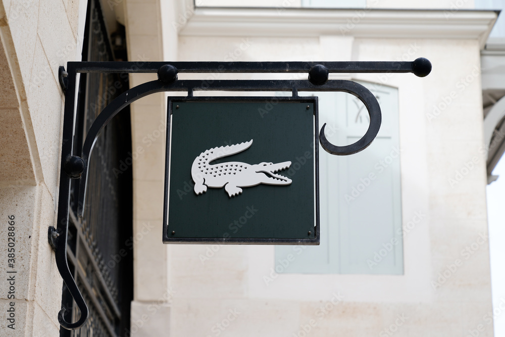 lacoste logo and text sign front of store french chain of luxury polo ...