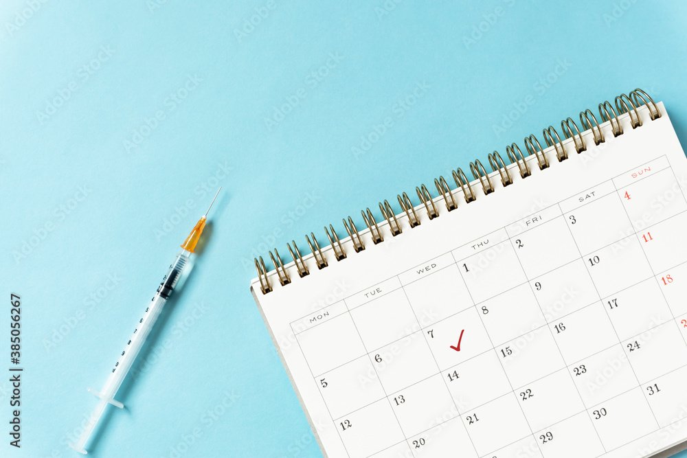 Syringe and calendar. Vaccinations, medicines, vaccines, flu injections ...