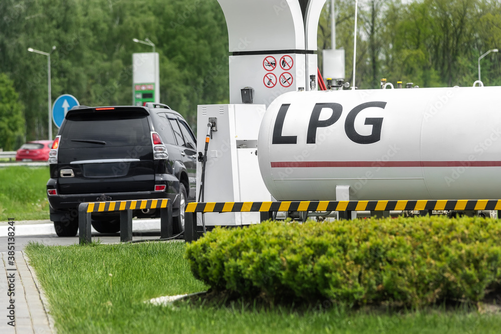 Liquid propane gas station. Black modern SUV car refueling tank with ...