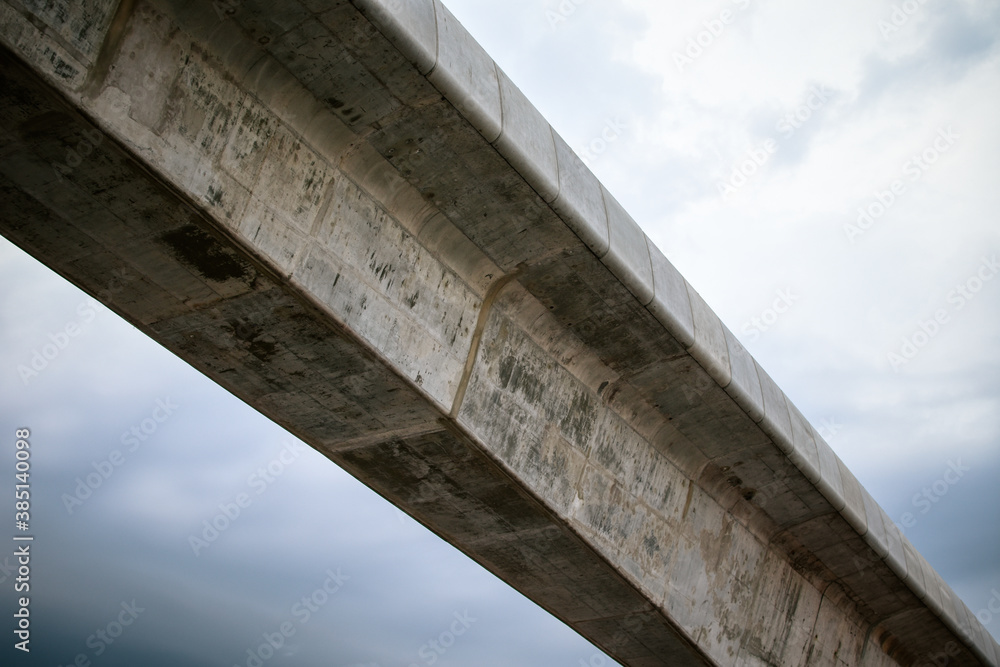 Bottom view of BTS Skytrain route under sky clouds in Bangkok, Thailand ...