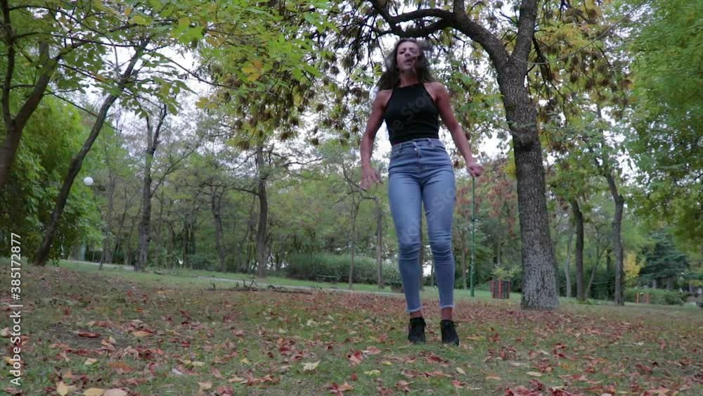 Female dancer dances with jumping and kicking her legs in the air in a ...