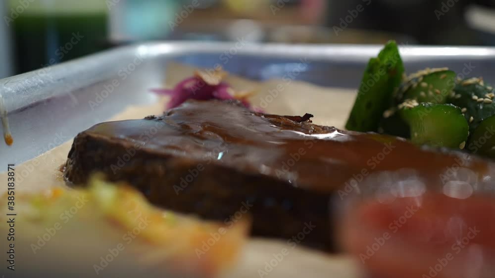 Inside restaurant kitchen bustle work orders. Chef pours delicious ...