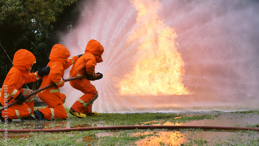 Firefighter fighting with flame using fire hose chemical water foam ...