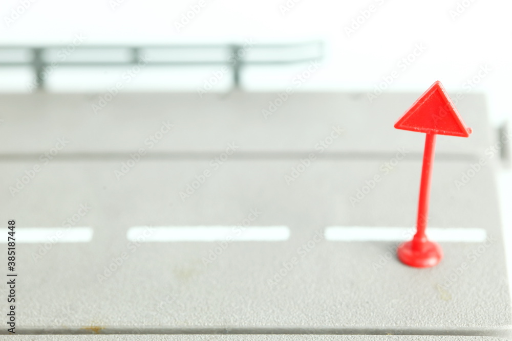 Miniature traffic signage put on the road plate model scene represent ...