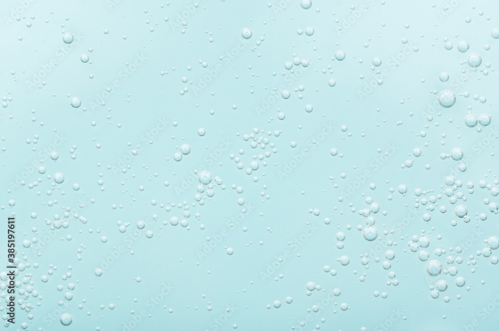 Transparent skin care cream on a blue background. The texture of a gel ...