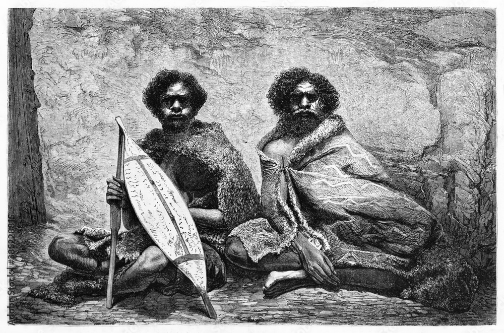 Two seated australian aboriginals in a dark shadows low light context ...