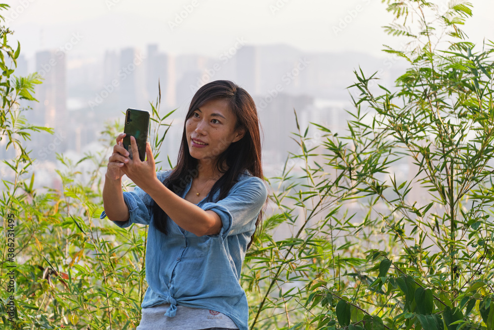 Beautiful Asian girl taking a selfie in the nature Stock Photo | Adobe ...