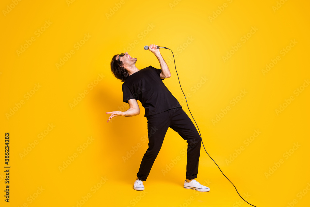 Full length profile photo of young man hold mic singer open mouth wear ...
