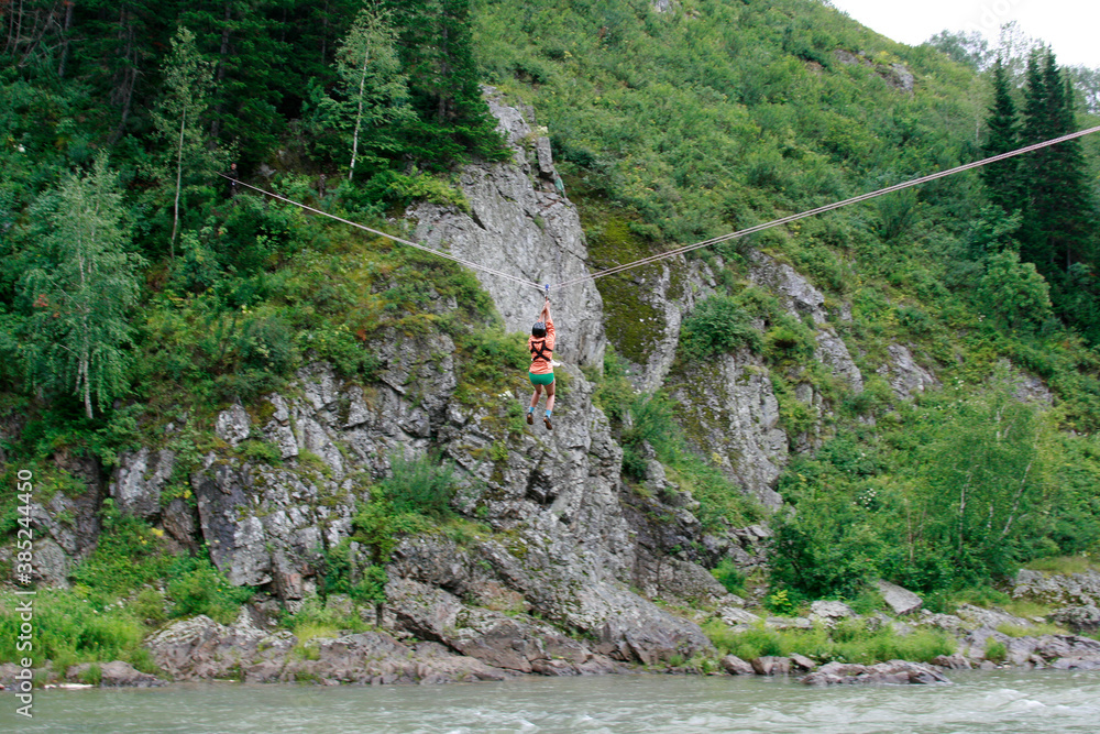 Extreme action, courage, Summer, rope crossing over a mountain river ...