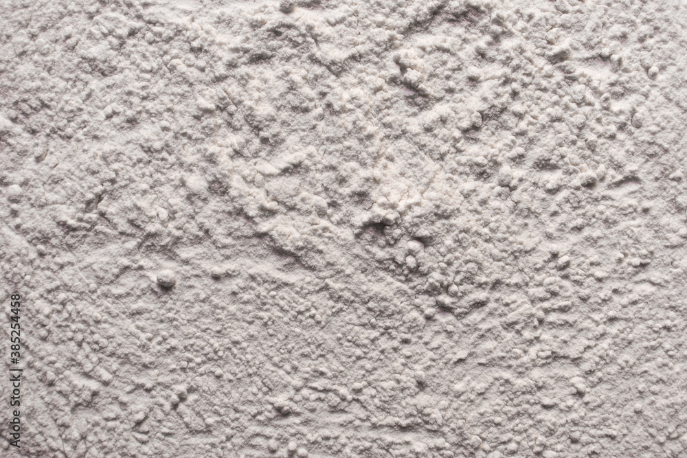 Texture of white fine flour powder with small ball lumps. Can be seen ...