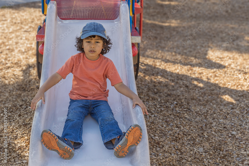 Stockfoto A casually dressed little boy looks at the camera when he ...