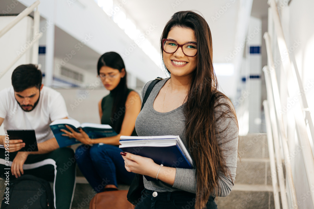 Foto de Portrait of young Brazilian student with backpack carrying ...