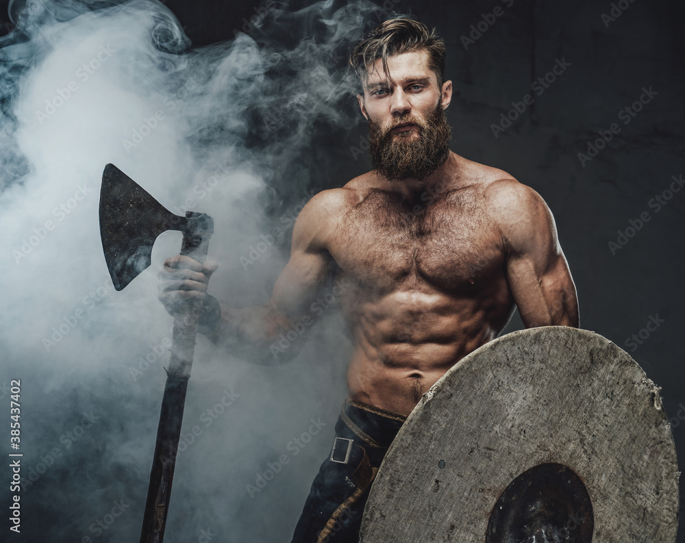 Ancient shirtless northern warrior with beard and muscular build posing ...