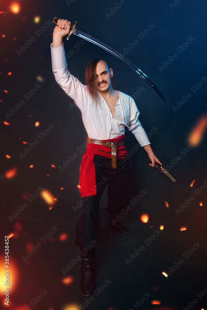Kozak with weapons in national Ukrainian clothes. A young man with a ...