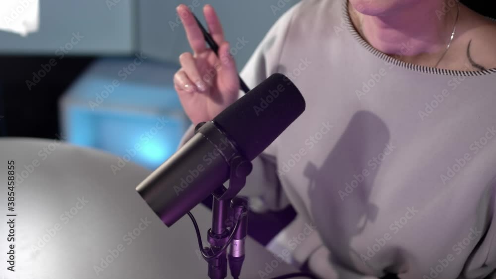 The evening news presenter sets up the microphone. Begins to tell ...