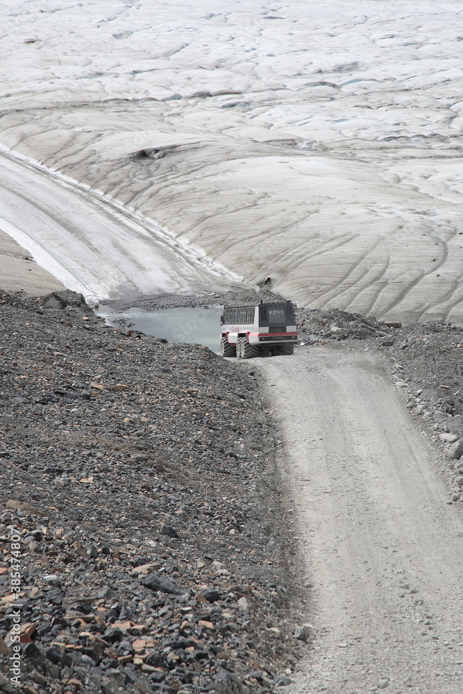 Ice Explorer massive vehicle snow coach bus driving on the ice road to ...