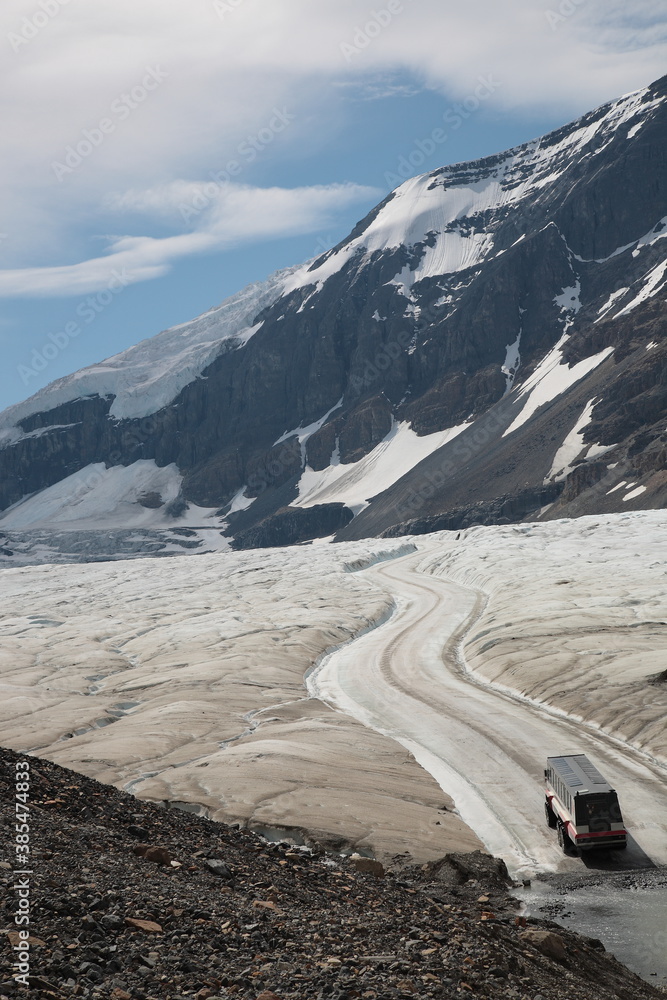 Ice Explorer massive vehicle snow coach bus driving on the ice road to ...